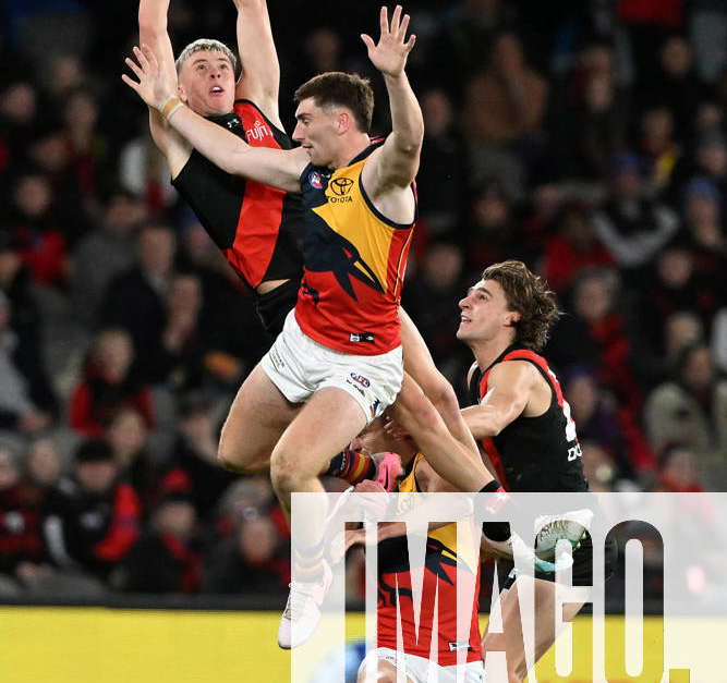 AFL BOMBERS CROWS, Nate Caddy of Essendon (left) contests a mark during ...