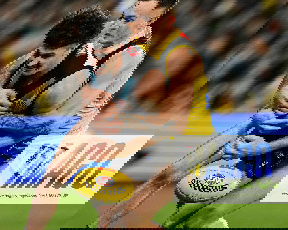 AFL POWER TIGERS, Darcy Byrne-Jones of Port Adelaide tackled by Rhyan ...