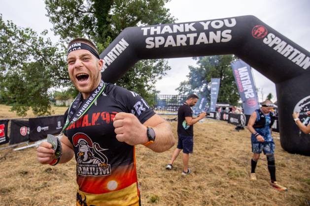 PXL_Spartan obstacle race Competitor celebrating after finish Santa ...