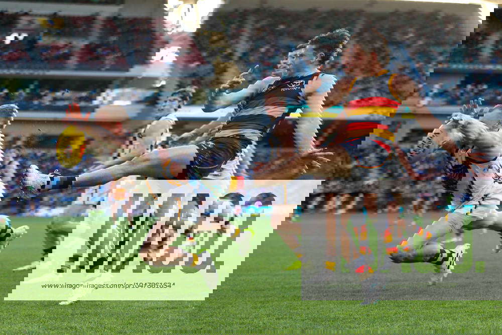 AFL CROWS HAWKS, Jake Soligo of the Crows kicks into James Worpel of ...