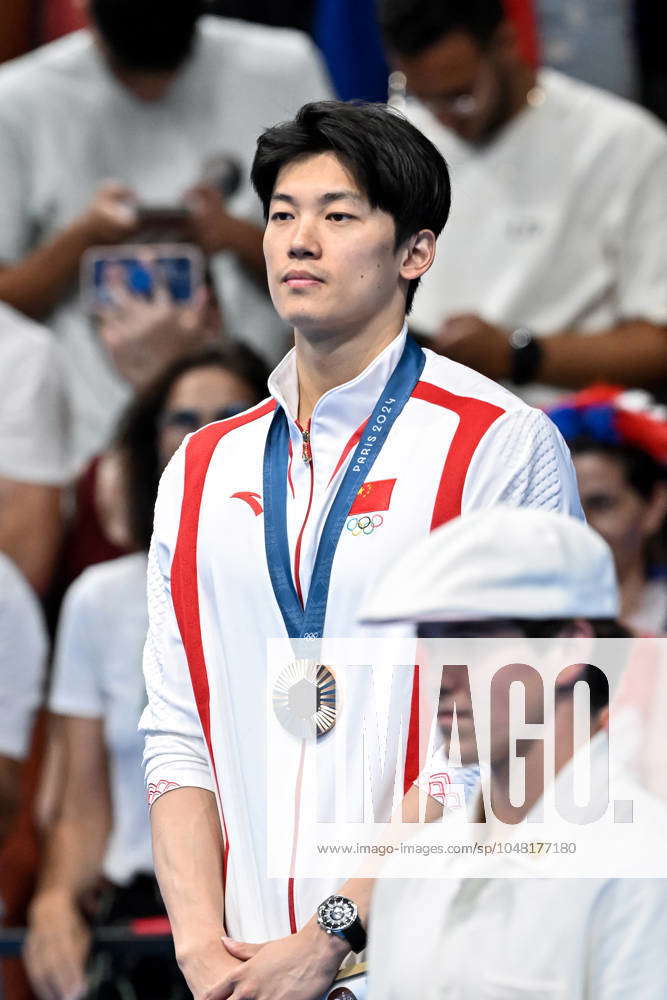 Shun Wang of China stands with the bronze medal after competing in the ...