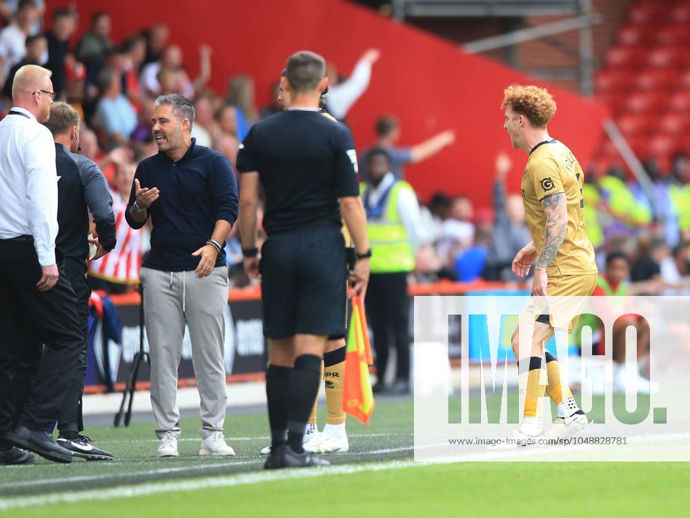 Jack Colback of Queens Park Rangers (R) shouts at the assistant referee ...
