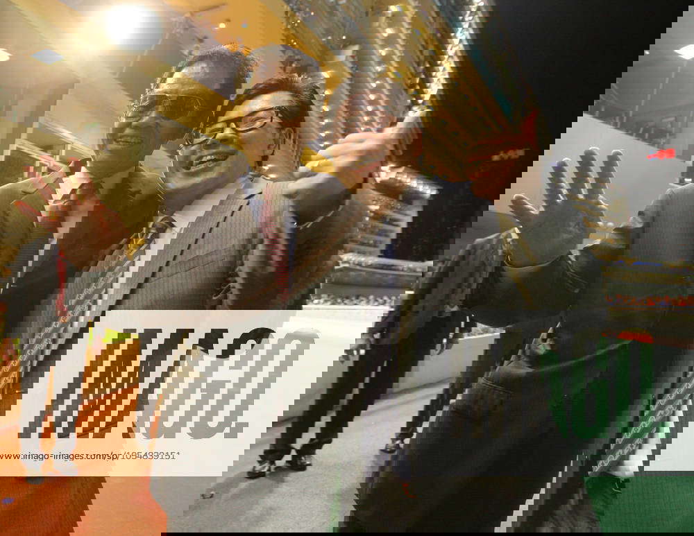 Race 9, trainer Dennis Yip Chor-hong (R), his horse Flying Elite won ...