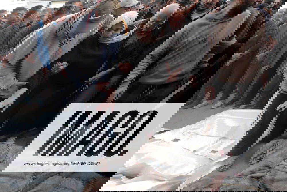 (241213) -- GAZA, Dec. 13, 2024 -- A woman mourns over victims killed in an Israeli airstrike at