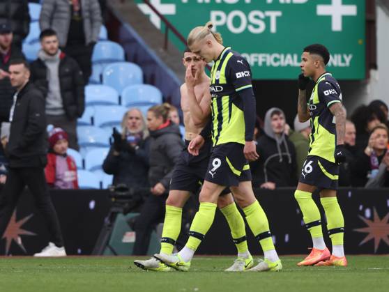 Phil Foden and Erling Haaland walk off dejected at the Aston Villa v ...