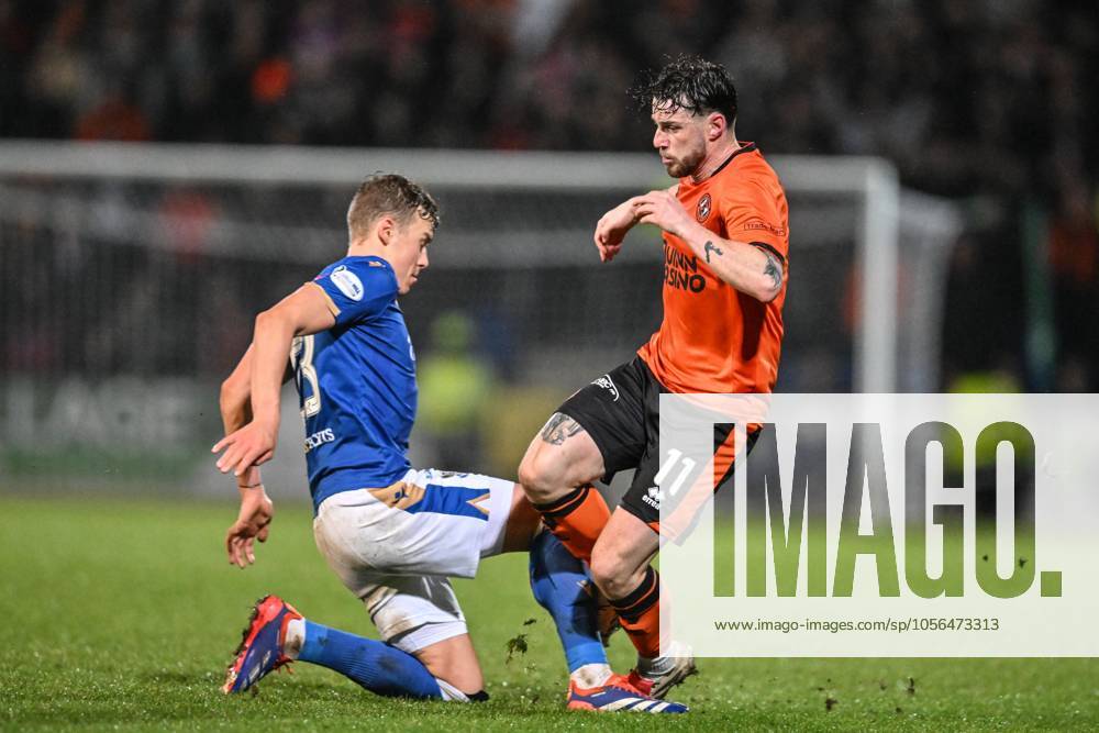 Ross Docherty of Dundee United is shown a yellow card bu referee Kevin ...