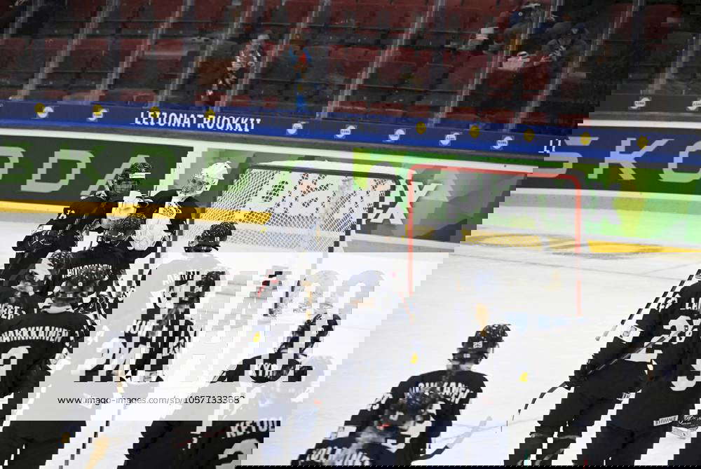 Finnish players gathering around goalkeeper Kerttu Kuja-Halkola to ...