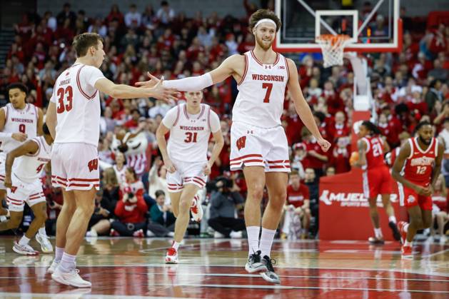: Wisconsin Badgers forward Carter Gilmore grimaces after he banked in ...