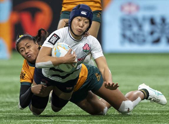 Vancouver, Bc, CANADA: Japan s Chiaki Saegusa, centre, is tackled by ...