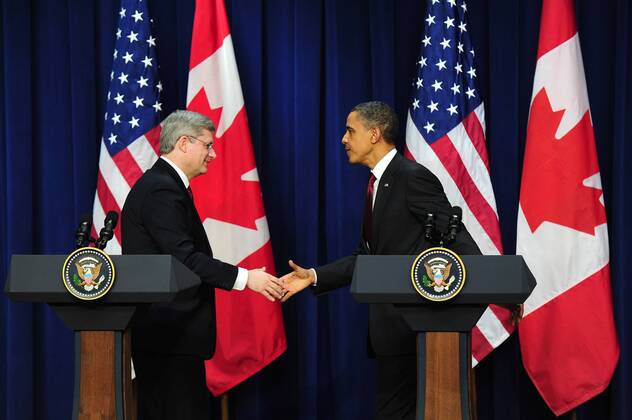 U.S. President Barack Obama (R) shakes hands with Secretary-General Ban ...