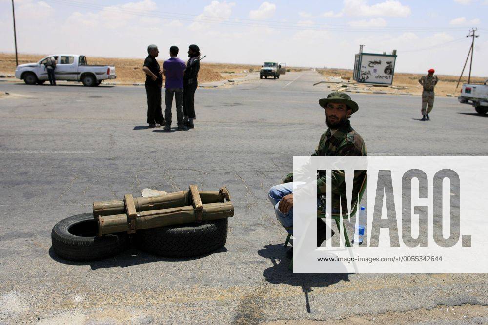 -- AJDABIYA, A Libyan rebel fighter rests at a crossroad in the city of ...
