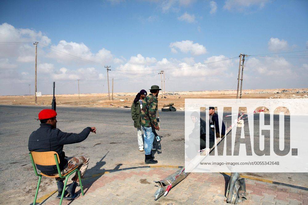 -- AJDABIYA, Libyan rebel fighters rest on a barricade in the city of ...