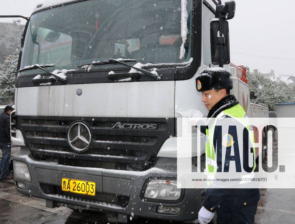 GUIYANG, Jan. 4, 2012 A traffic official works in snow on a highway in ...