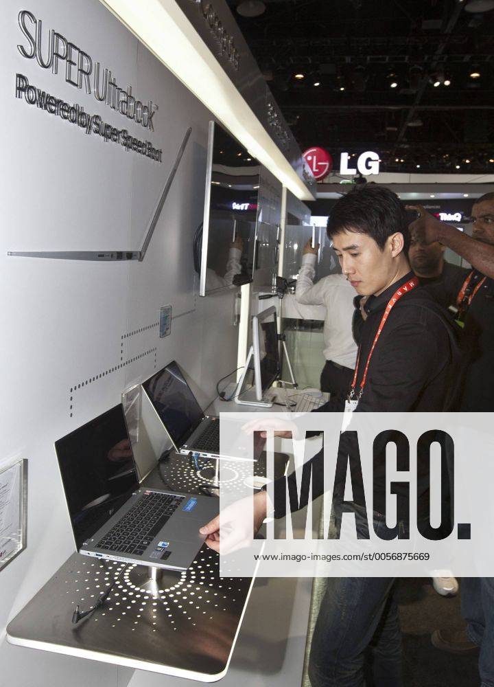 A man checks out the LG Ultrabooks at the LG exhibit at 2012 ...