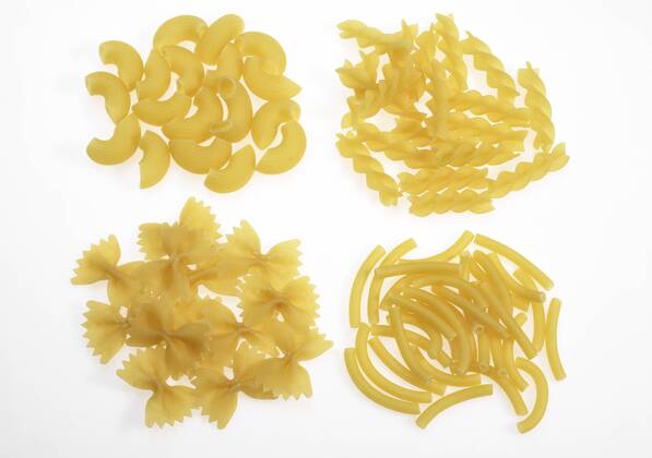 Shells, Macaroni, Spaghetti and Twisted Pasta Against White Background ...