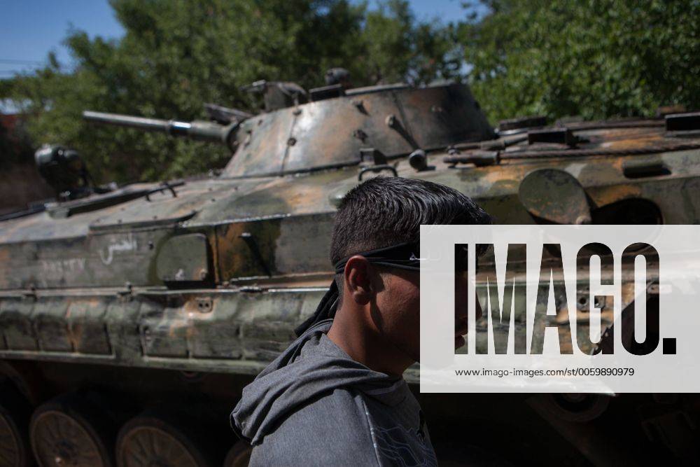 Syria A rebel soldier from the FSA stands up besides of a BMP-1 tank ...