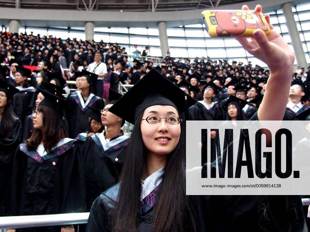 SHANGHAI, A student poses for photo during the 2013 Graduation Ceremony ...
