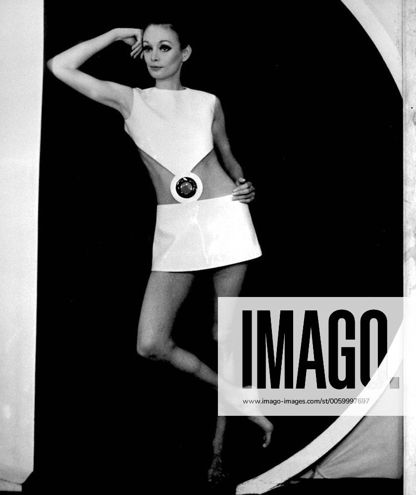 A tiny white vinyl plastic mini dress relieved by a little red and ...