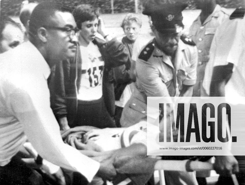 Kingston, Jamaica: England s Janet Simpson is carried of the track on a ...