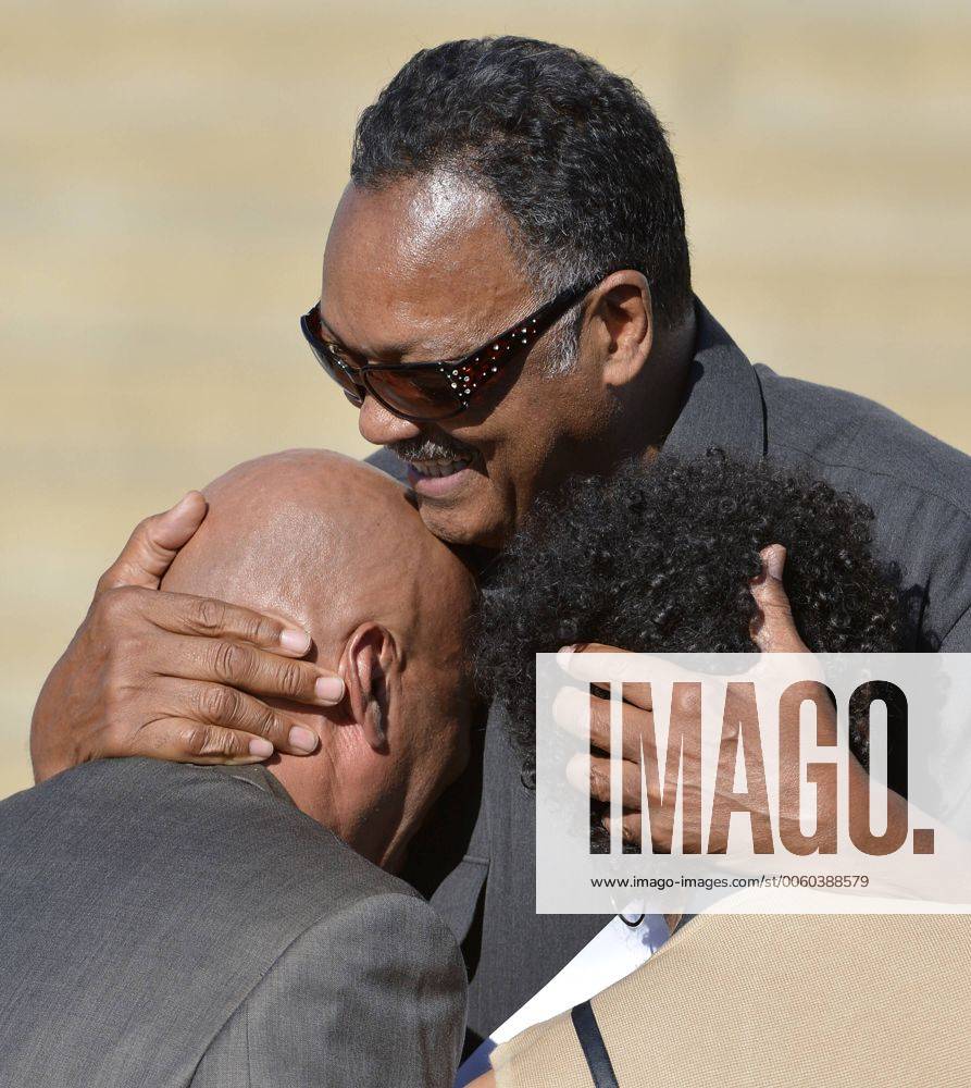 Civil rights activist Rev Jesse Jackson hugs unidentified guests as he ...