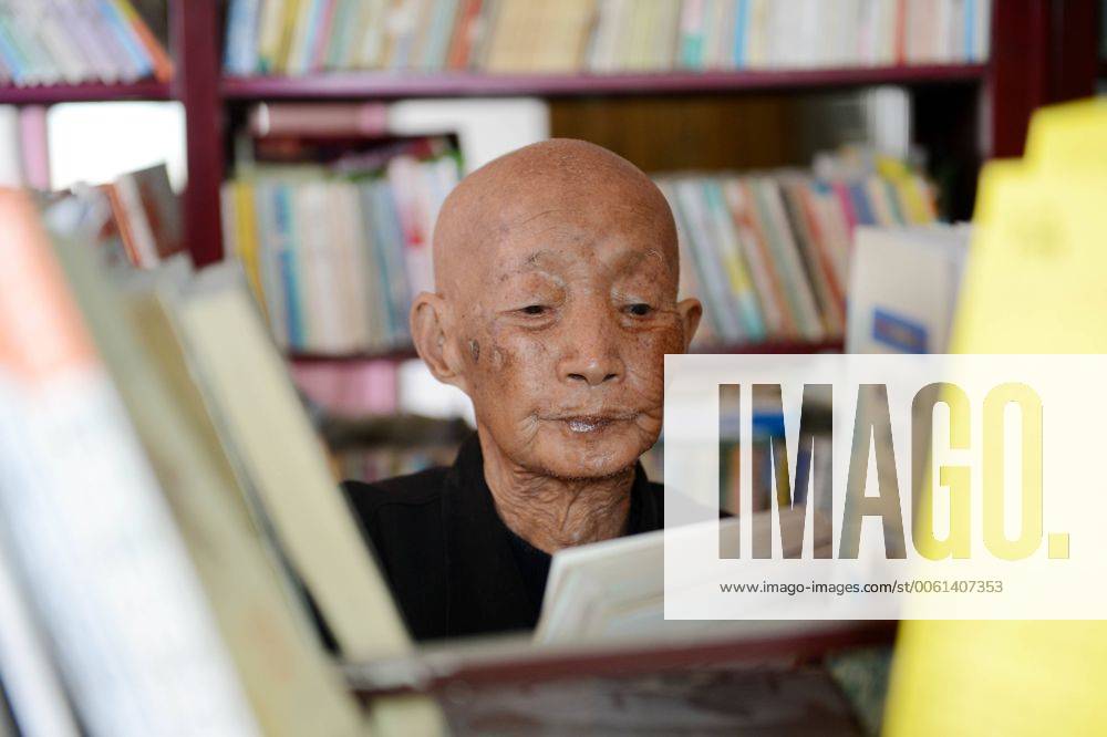 NANCHANG, Chen Renyuan arranges books at his library in Sanlian Village ...