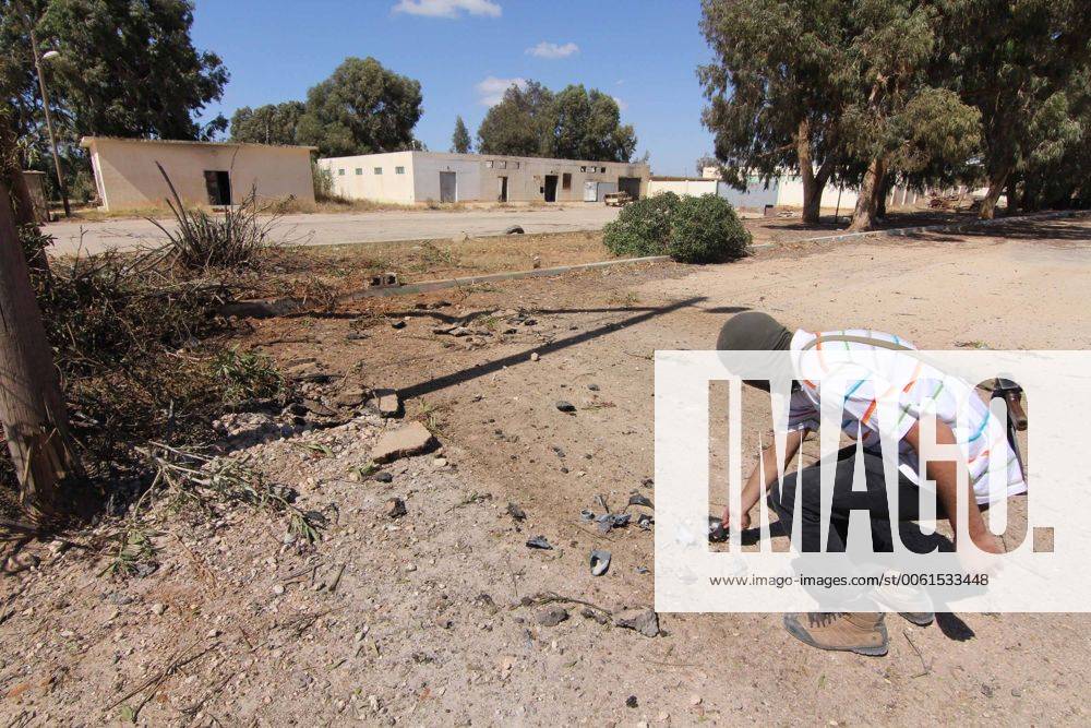 -- BENGHAZI, -- A soldier of the February 17 Brigade picks remains of ...