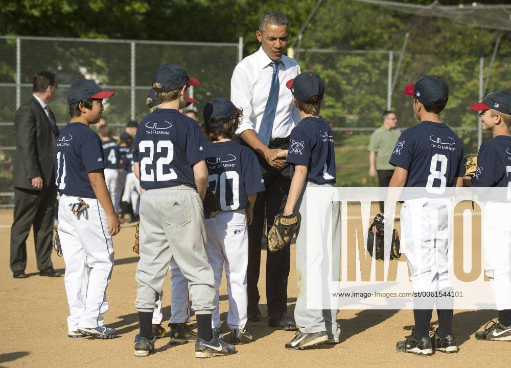 President Barack Obama greets players as he visits a little league game ...