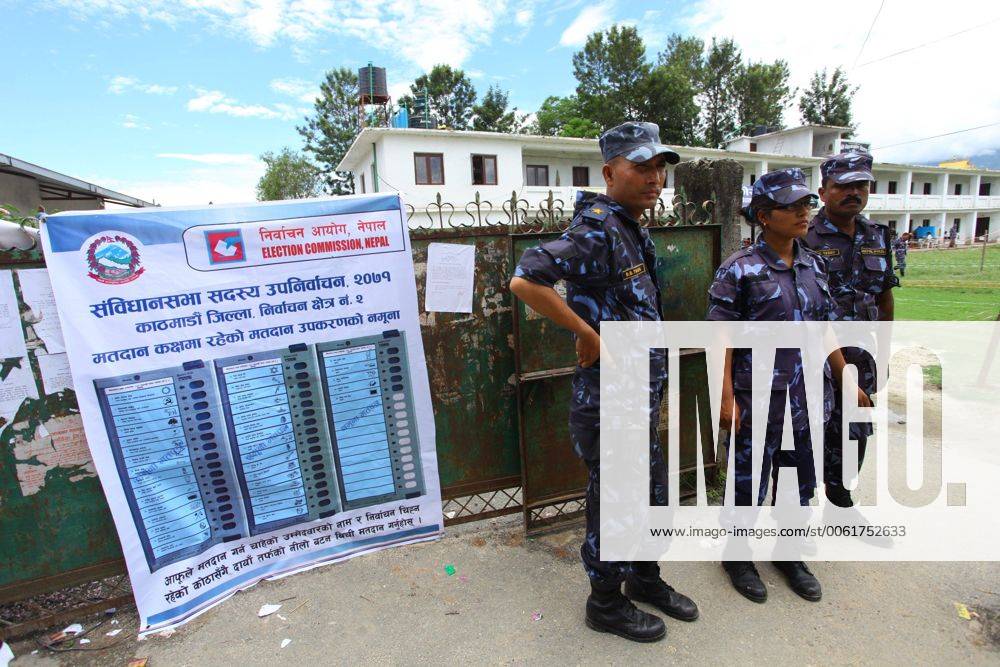 Security personnel stand guard at a polling booth during Constituent ...