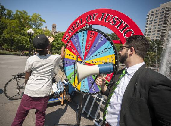 NYCLU volunteer Evan Altshuler armed with a bullhorn acts as master of ...