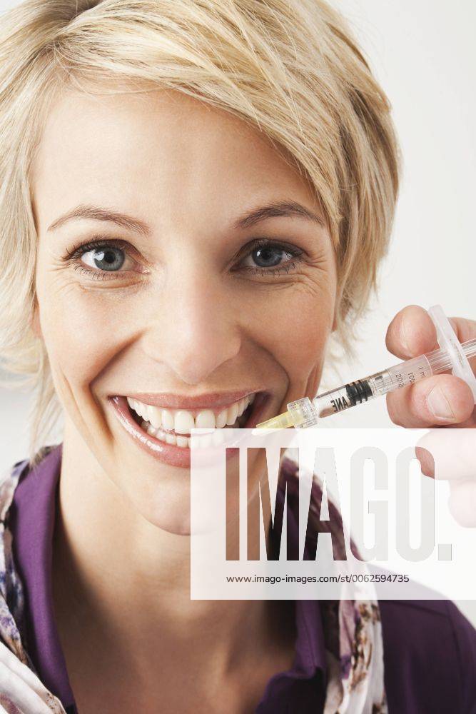 Germany, Munich, Doctor giving Botox treatment to woman model released ...