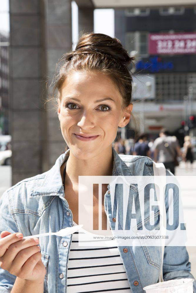 Germany, Berlin, Young women in the city, eating icecream model released