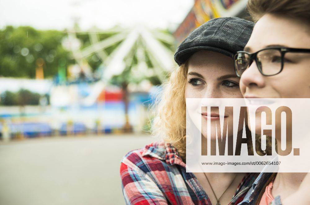 Portrait of happy teenage couple at fun fair model released
