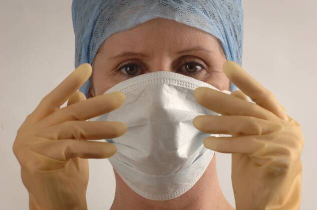 Close up of a hospital worker wearing a hygiene mask and