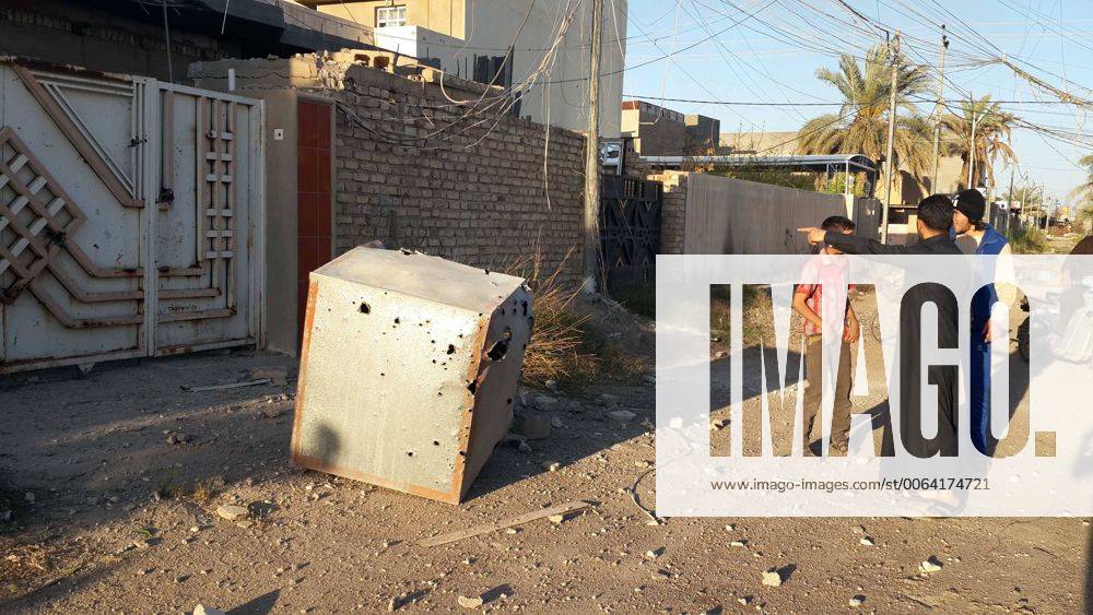 FALLUJAH, People stand by a damaged house after Iraqi Air Force bombing ...