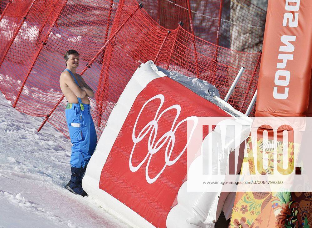 SOCHI, Russia - A Winter Olympics staff member naked to the waist watches the women s alpine skiing