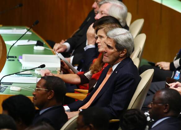 U.S. Secretary of State John Kerry listens to a translator relay his ...