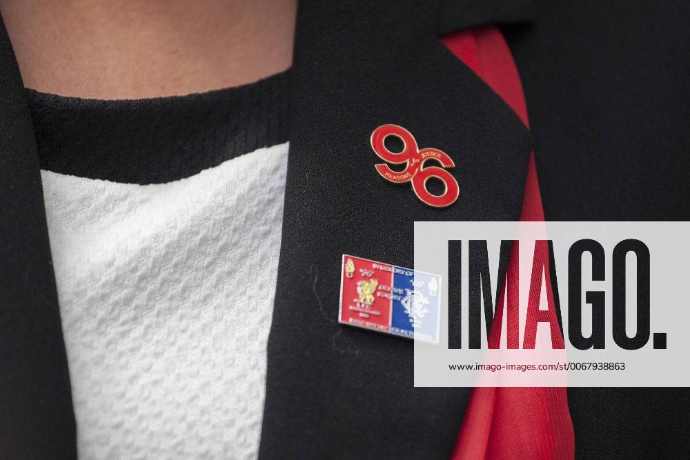 Louise Brooks, who lost her brother Andrew Mark Brooks, wears a badge ...