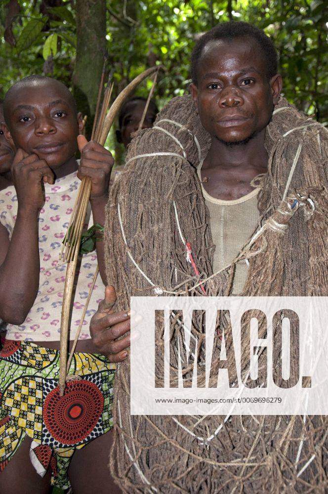 Mbuti Pygmies initiation hunt, men with bow and arrows and another with ...