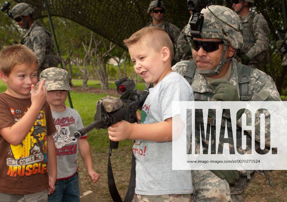 Aug. 13, 2011 - Fayetteville, North Carolina, U.S. - A young visitor tries his hand with an M