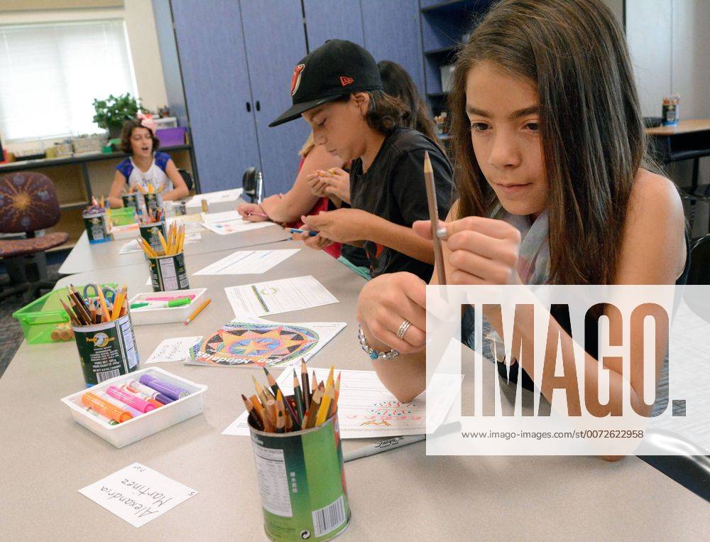 Albuquerque, NM, U.S. - Fifth grader Alexandra Martinez looks to pick ...