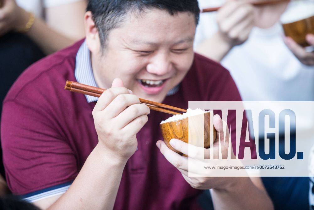 HANGZHOU, CHINA - AUGUST 02: A participant eats cooked rice on a taste ...