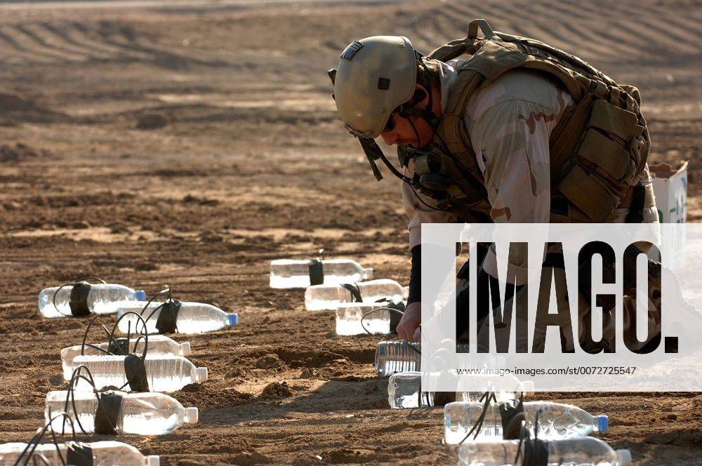 Soldier links explosives together for a test detonation at a range in ...