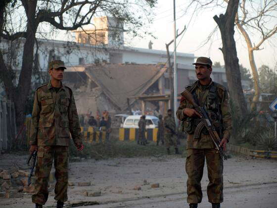 PESHAWAR, Nov. 13, 2009 -- Security force members stand guard after a ...