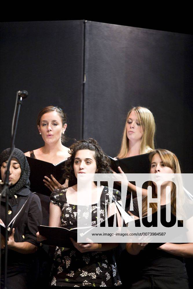 A group of teenage girls sings in a sound studio. (Editorial Usage Only