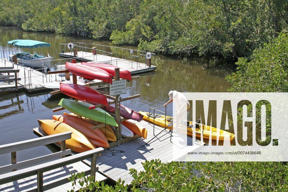 Fisherman launching kayak at boat pavilion Conservancy Nature Center ...