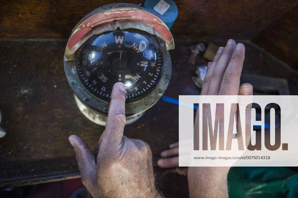 Fishermen checking compass model released Symbolfoto property released
