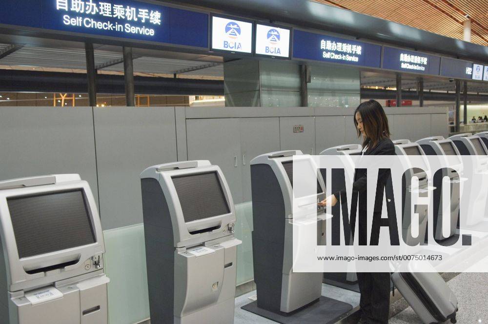 A Chinese business woman using the self service check in machines at ...