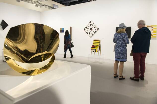 Visitors observe the works of Dan Gunn Gallery during the art fair Art ...