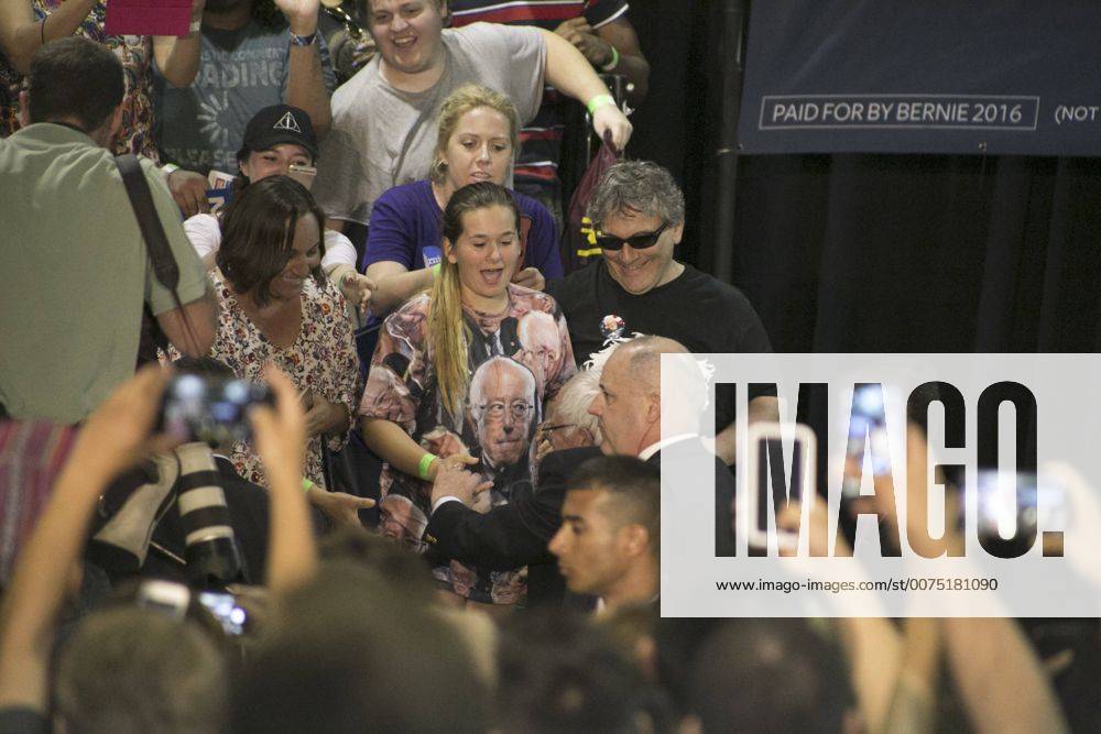 Senator Bernie Sanders signs a young girls shirt of his face at a rally ...