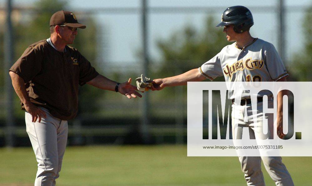 Yuba City High School head coach Jim Stassi takes the gloves of his son ...